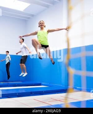 Woman training in trampoline center Stock Photo - Alamy