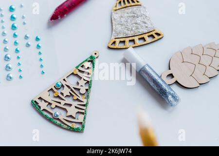 Girl makes wooden crafted Christmas ornaments at home, recyclable craft ...