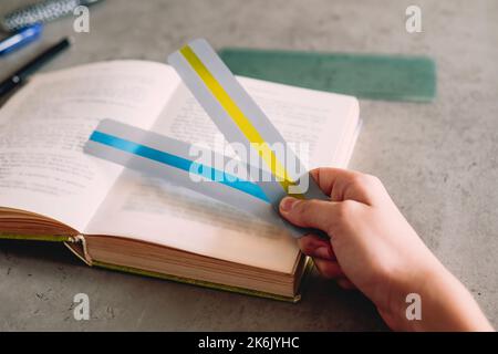Reading tools for dyslexia. Child reading book using colorful ruler ...
