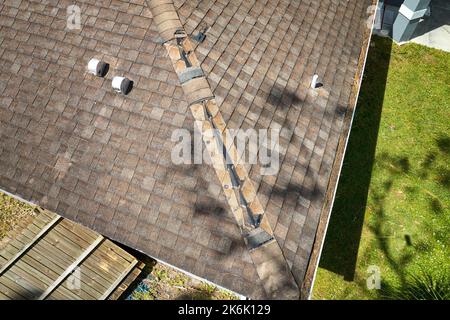 Wind damaged house roof with missing asphalt shingles after hurricane ...