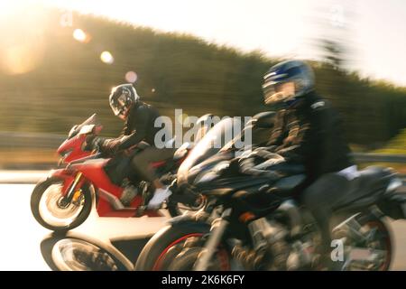 Two supersport race motorcycle riders going fast side by side on the ...