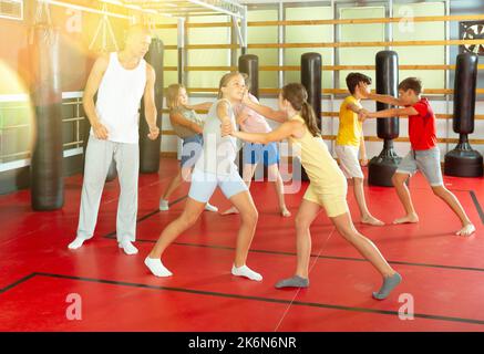 Children practicing self defence technique in pairs Stock Photo - Alamy