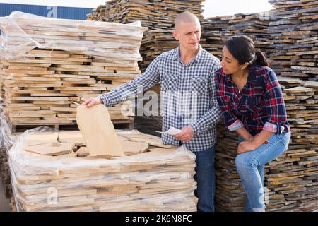 Buyers choose natural stone tiles in the open area of hardware store ...