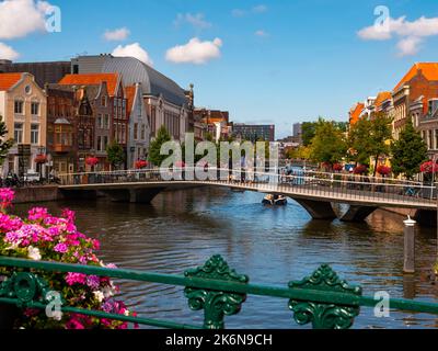 Scenic cityscape of Leiden with townhouses and embankments along canal ...