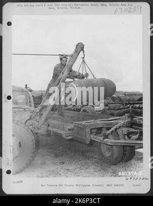 Aircraft munitions are being loaded onto a Republic P-47 Thunderbolt of ...