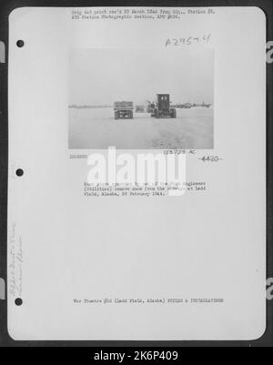 Snow plows operated by men of the Post Engineers (Utilities) remove ...