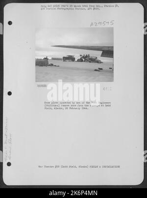 Snow plows operated by men of the Post Engineers (Utilities) remove ...