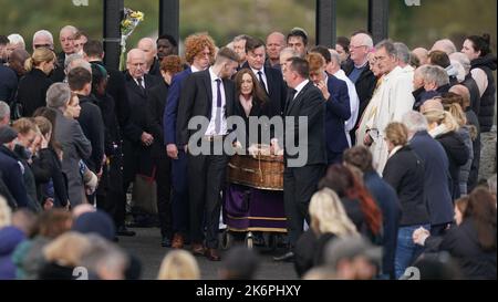 Robert Garwe's partner Aine pushes her daughters coffin from St Michael ...