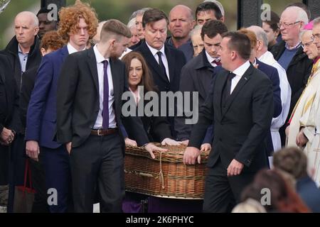 Robert Garwe's partner Aine pushes her daughters coffin from St Michael ...