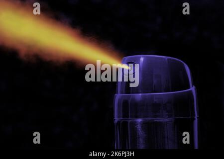Aerosol deodorant can firing hot colored spray Stock Photo - Alamy