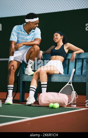 Young tennis players talking after the game Stock Photo - Alamy