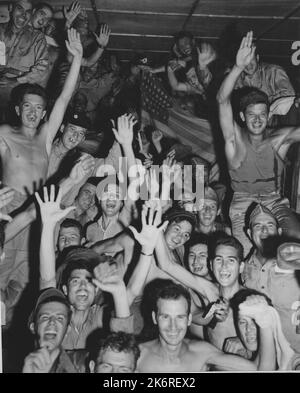 Allied prisoners of war at Aomori camp, near Yokohama, wave flags of ...