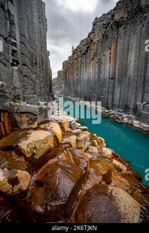 Stuolagil Canyon, turquoise river between basalt columns, Egilsstadir ...
