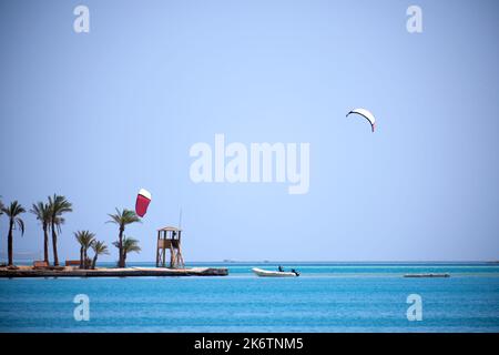 Tropical sea pier with palms and recreational zone, tourists ...
