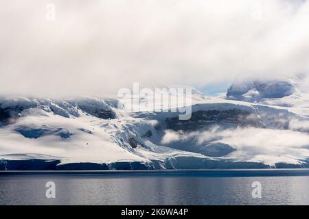 snow and cloud covered mountains. gerlache strait. antarctic peninsula ...
