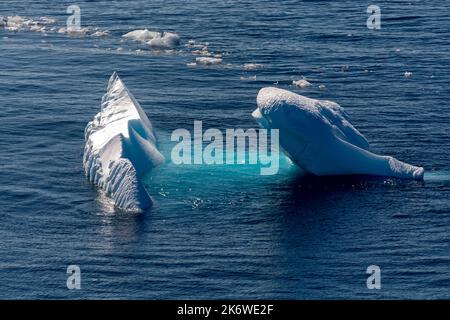 iceberg with two parts above water joined underwater. near northern ...