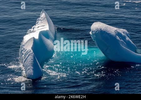 iceberg with two parts above water joined underwater. near northern ...