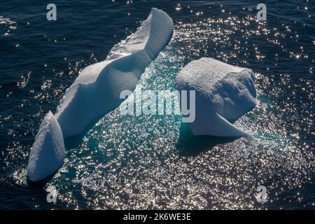 iceberg with two parts above water joined underwater. near northern ...