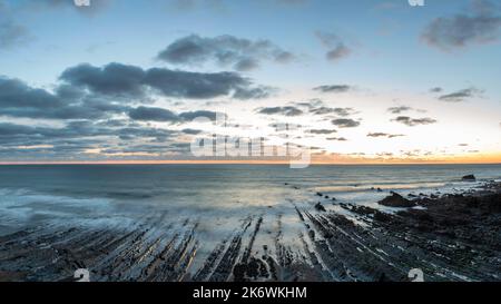 Stunning sunset landscape image of Welcome Mouth Beach in Devon England ...