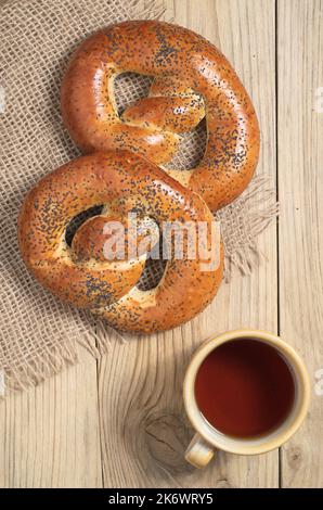 Delicious pretzels with poppy seeds on pink background Stock Photo - Alamy