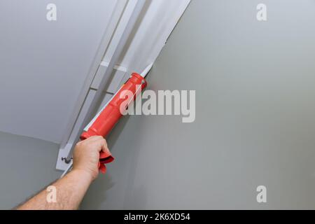 Construction worker using silicone sealant caulk the outside window frame Stock Photo - Alamy