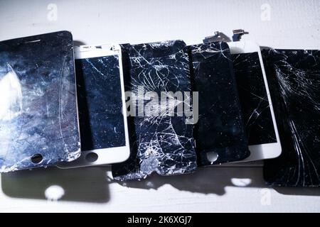 Mobile tablet device with a broken badly cracked shattered glass on the ...