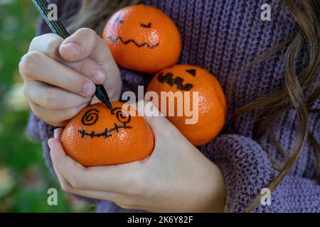 Cropped shot of child preparing for holiday Halloween, hands of child ...