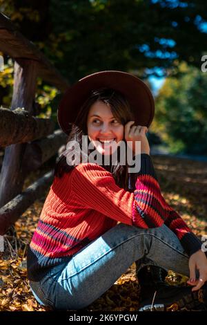 happy woman posing near fence autumn sunny day Stock Photo - Alamy