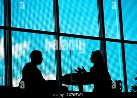 Boss speaking to employees at night Stock Photo - Alamy