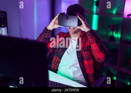 Young caucasian man streamer playing video game with winner expression ...