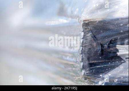 Selective focus on cellophane shrink wrap on pallets of goods for ...