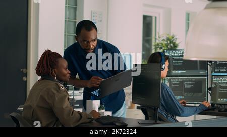 Database web developers developing source code and cloud computing in it big data office room ...