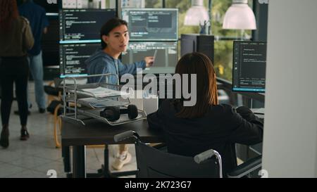 Software developer with chronic disability writing code, computing big data to create app ...