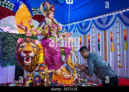 A person before an idol of Maa Durga at a mandal in Mumbai for the ...