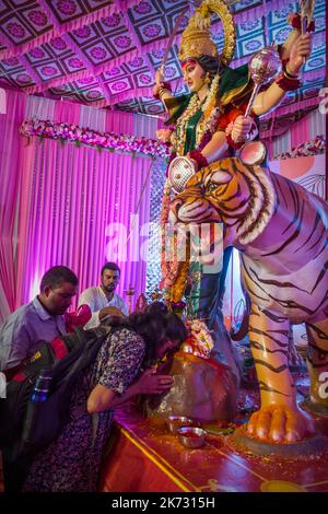 A person before an idol of Maa Durga at a mandal in Mumbai for the ...