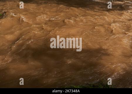 River flooding with muddy waters making rapids and waves Stock Photo ...