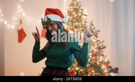 Girl dances next to christmas tree Stock Photo - Alamy