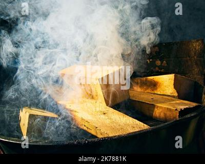 Smoke from falling wood for the barbecue Stock Photo - Alamy