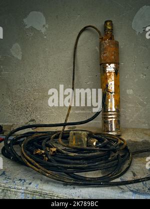 Old rusty submersible pump for drinking water Stock Photo - Alamy