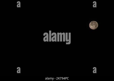 Full moon in a completely dark sky Stock Photo - Alamy