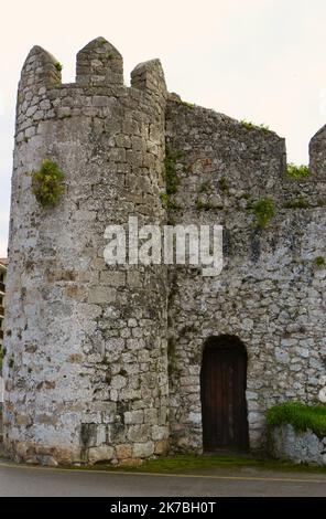 Medieval castellated stone wall tower and wooden door Llanes Asturias ...