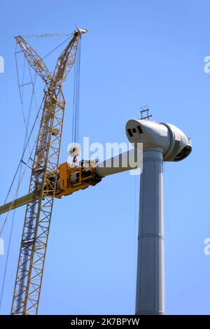 Constructing wind-turbines by using a large crane Stock Photo - Alamy