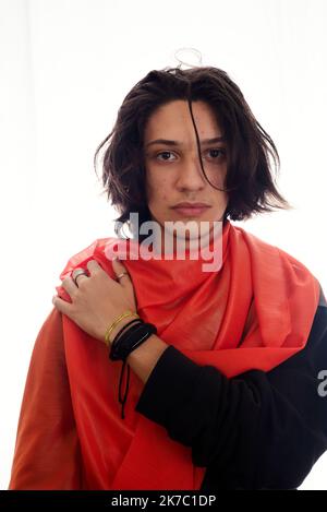 Brazilian young man standing over brick wall skeptic and nervous ...