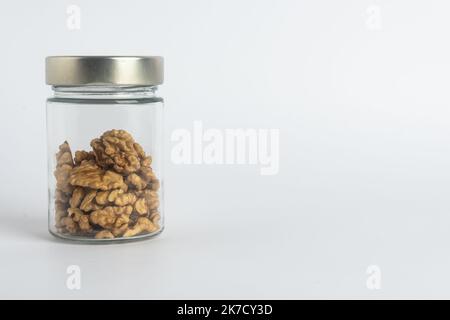 The walnut kernels in jar isolated on white background. close-up walnut ...