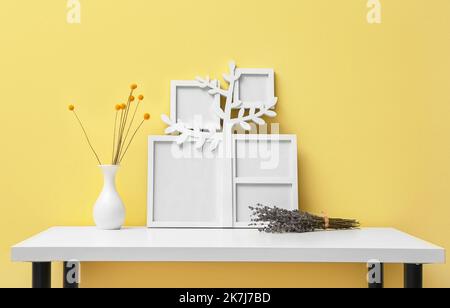 Family tree with photo frames, vase and cotton flowers on shelf near ...