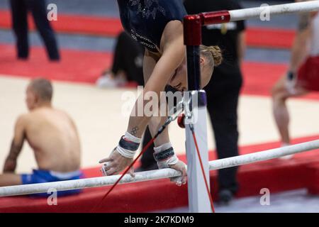 Aline Friess, of France, performs on the uneven bars during the women's ...