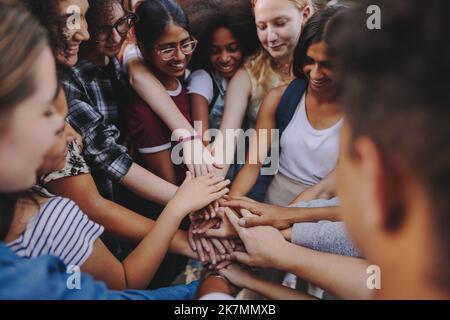 group of happy kids putting hands together Stock Photo - Alamy