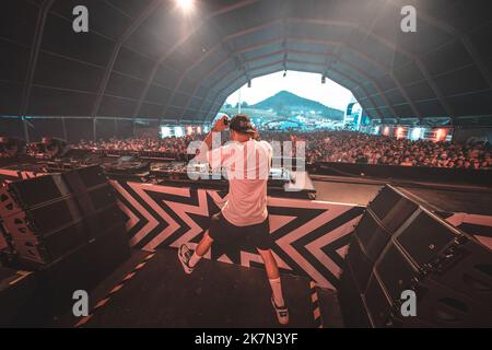 A behind stage high-angle of rear male singer performing on the stage ...