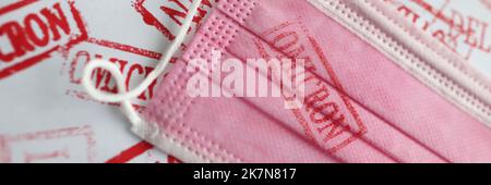 Red omicron stamp on a pink mask, close-up Stock Photo - Alamy