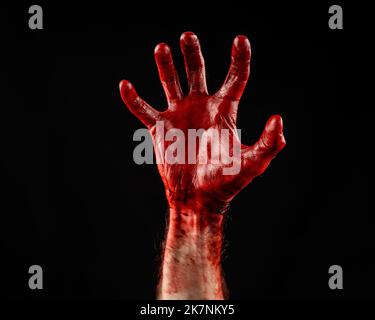 Male palm stained with blood on a black background Stock Photo - Alamy